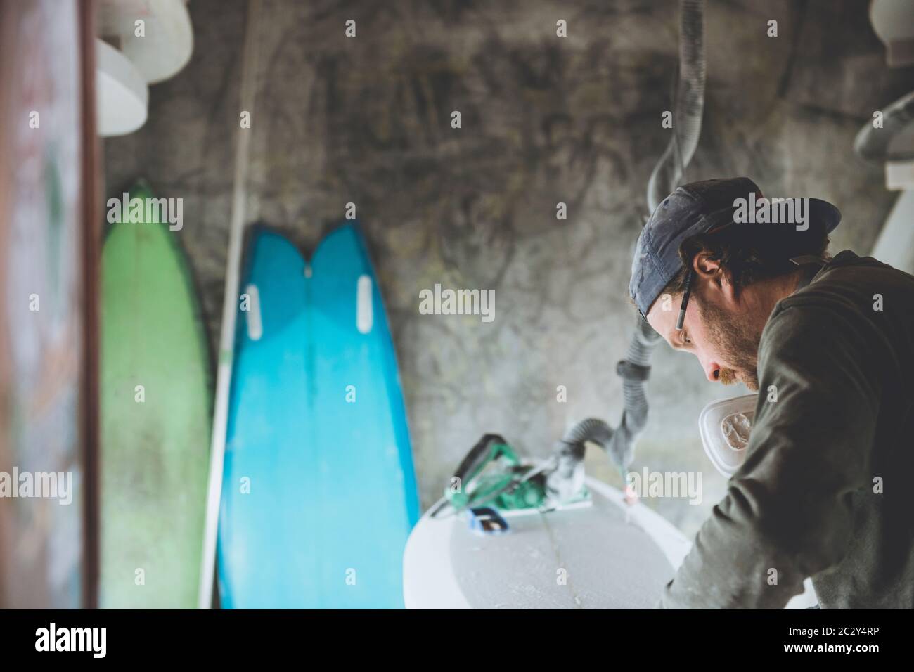 Surfboard Shaper refining a new design Stock Photo - Alamy