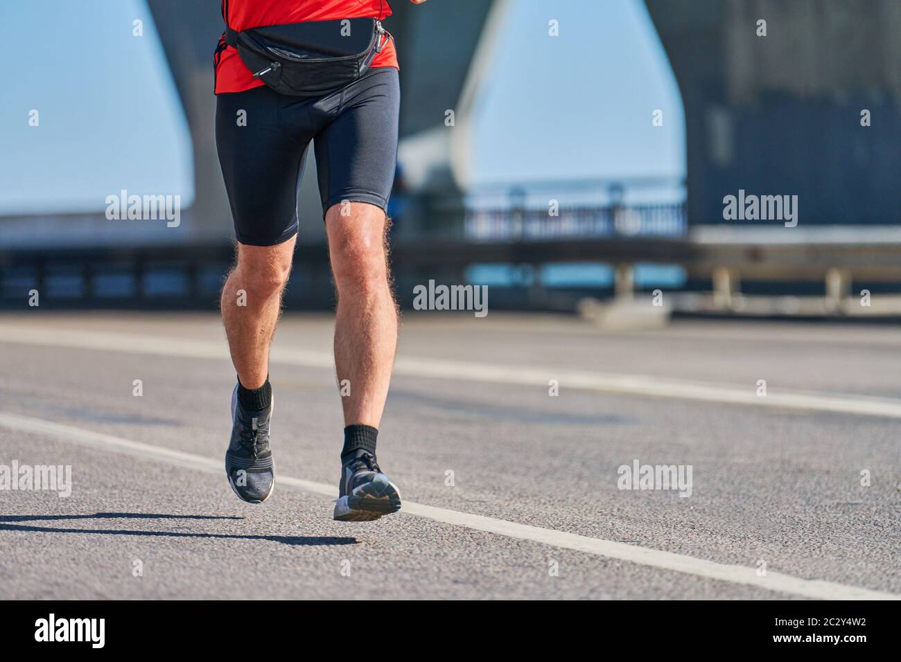 Running man. Athletic man jogging in sportswear on city road. Healthy ...