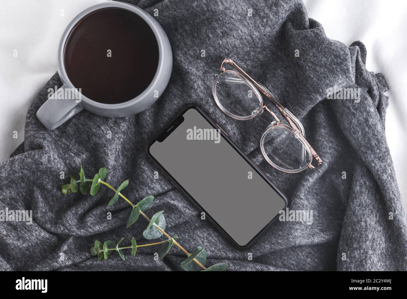 Electronics layout in a white and gray bed flat lay Stock Photo - Alamy