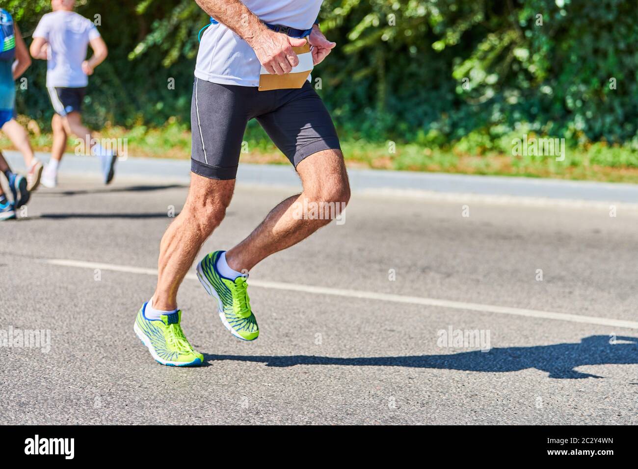 Running man. Athletic man jogging in sportswear on city road. Healthy ...