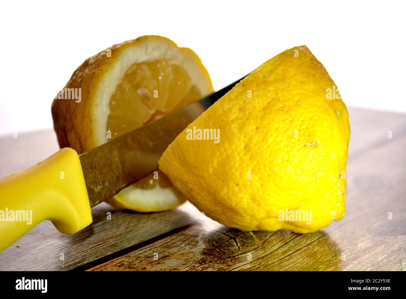 lemon cut in half with knife Stock Photo - Alamy