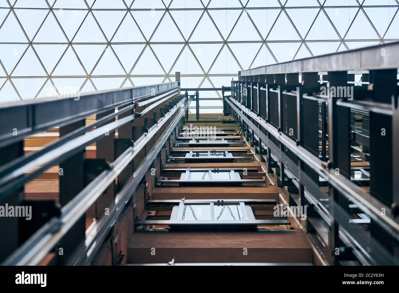 Open elevator lift shaft. Modern architecture with transparent ceiling ...