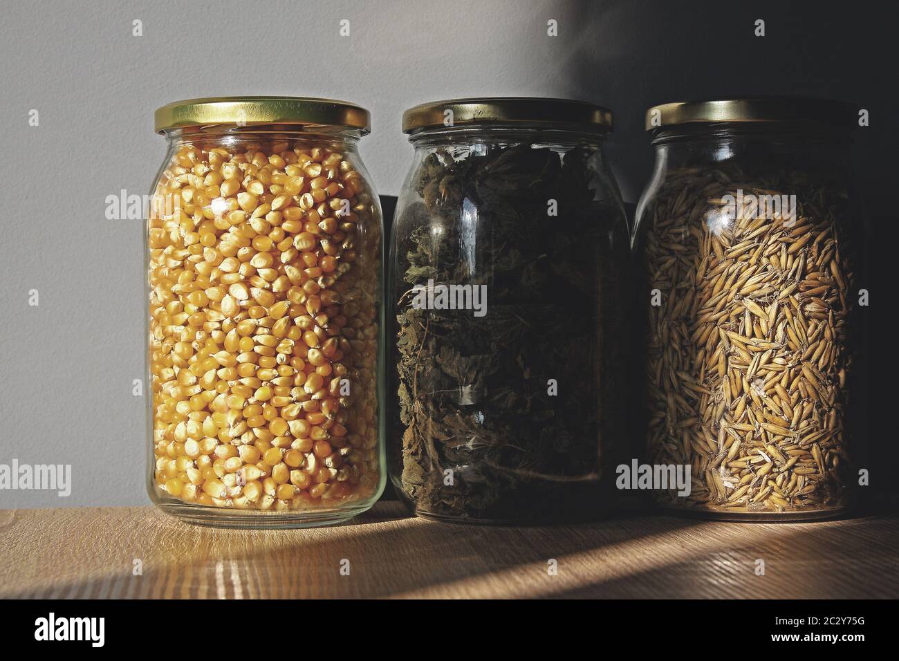 Herbs, cereals and corn in jars for storage in the pantry Stock Photo ...
