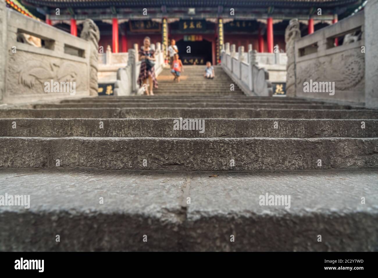 Unidentifiable people walking down the stairs leading to the Buddhist ...