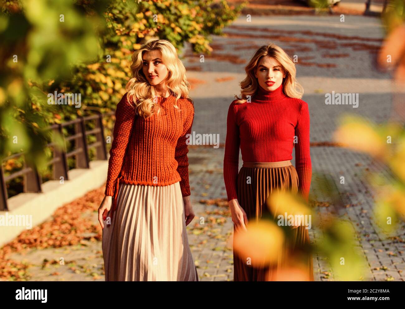 Friends girls. Autumn stylish outfit. Adorable ladies enjoy sunny ...