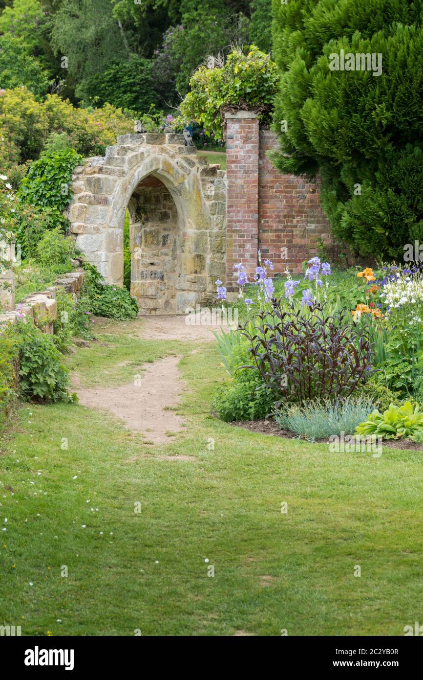An ancient stone arch in a formal garden in Kent, England Stock Photo ...