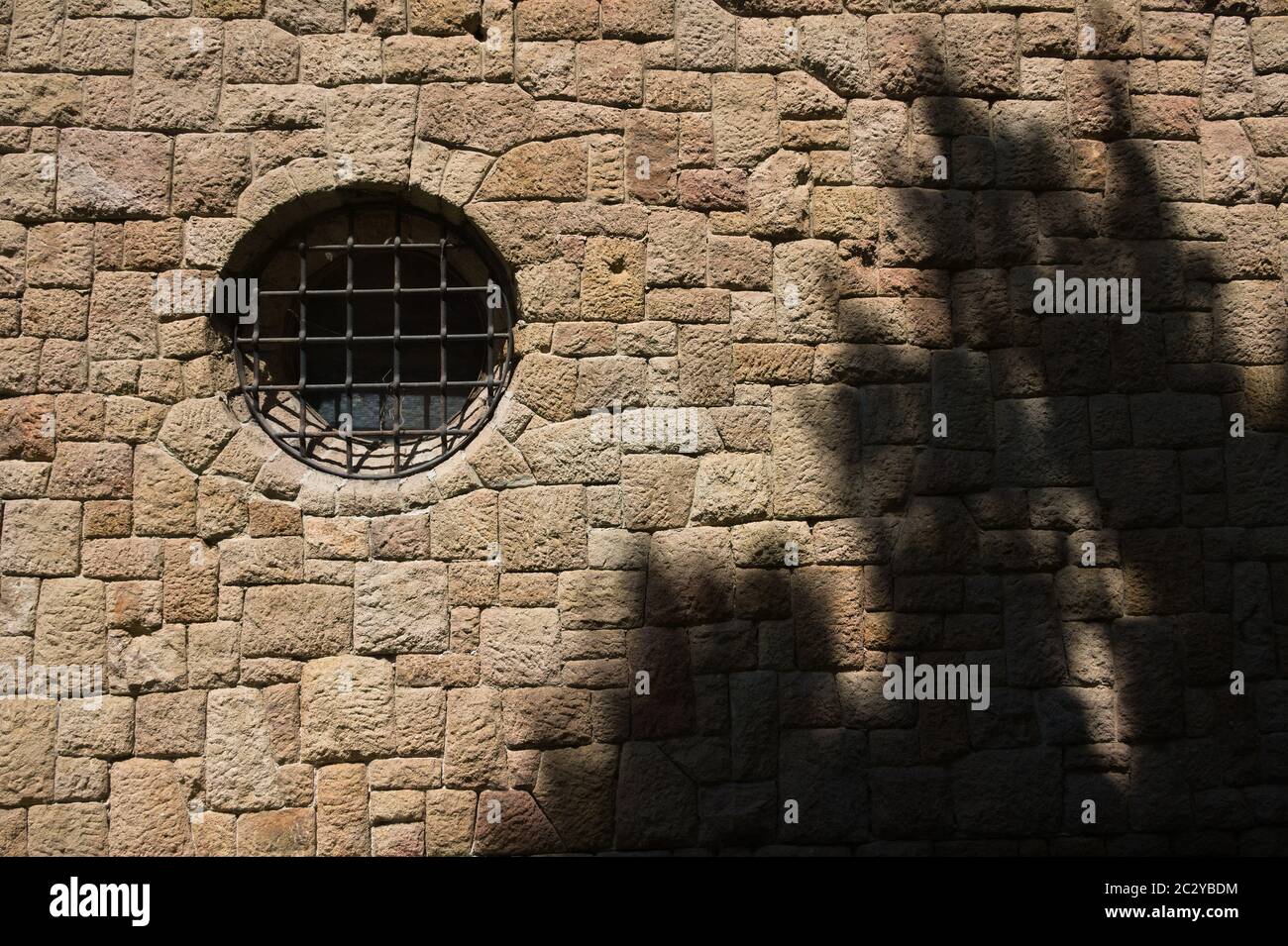 Stone wall with circular church window with wooden shadow Stock Photo ...