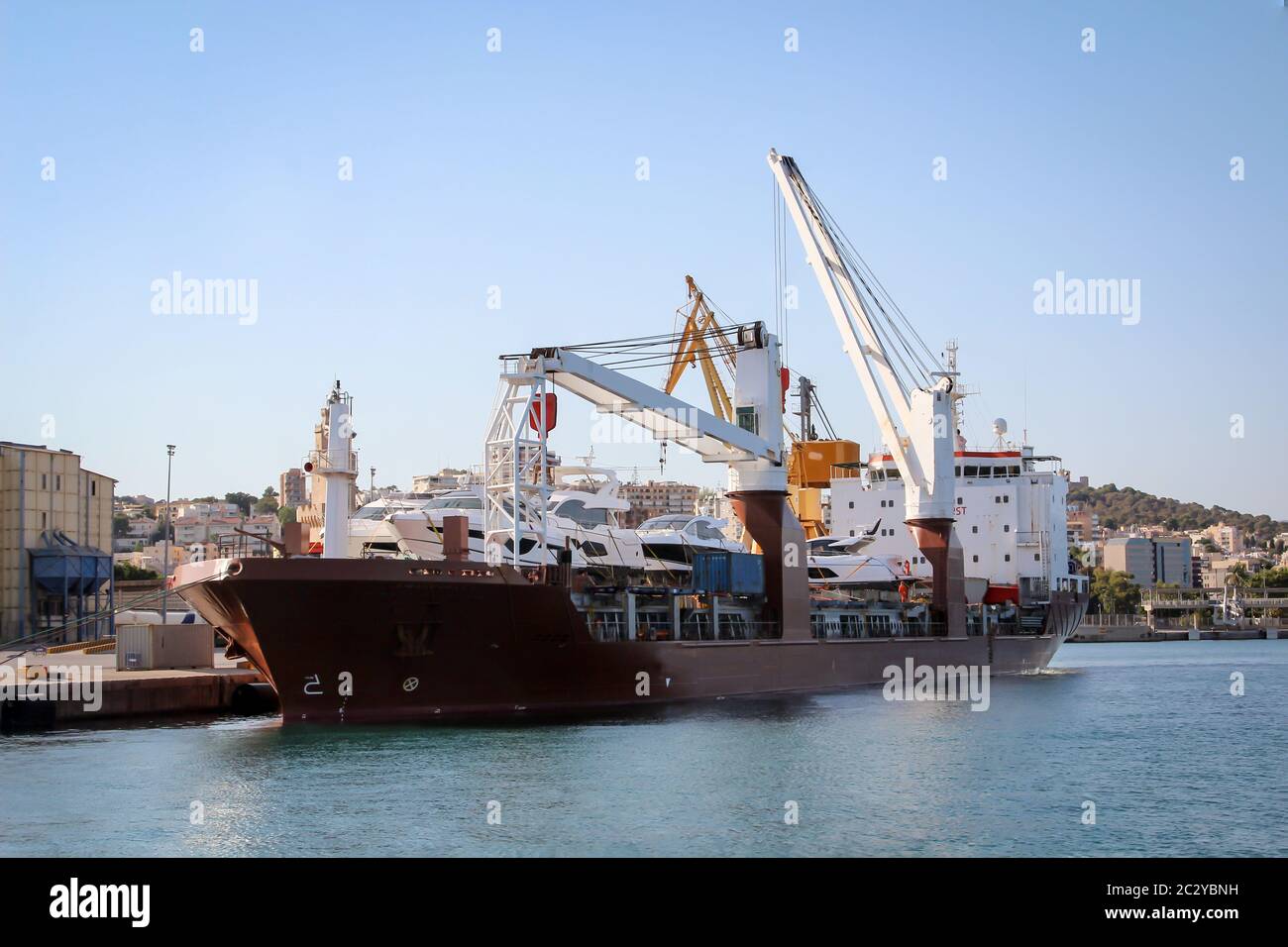 A big transport ship is loaded with some yachts Stock Photo - Alamy