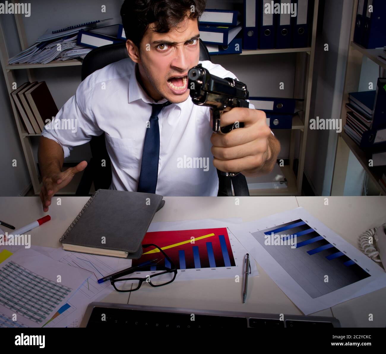 Man businessman working late hours in the office Stock Photo - Alamy