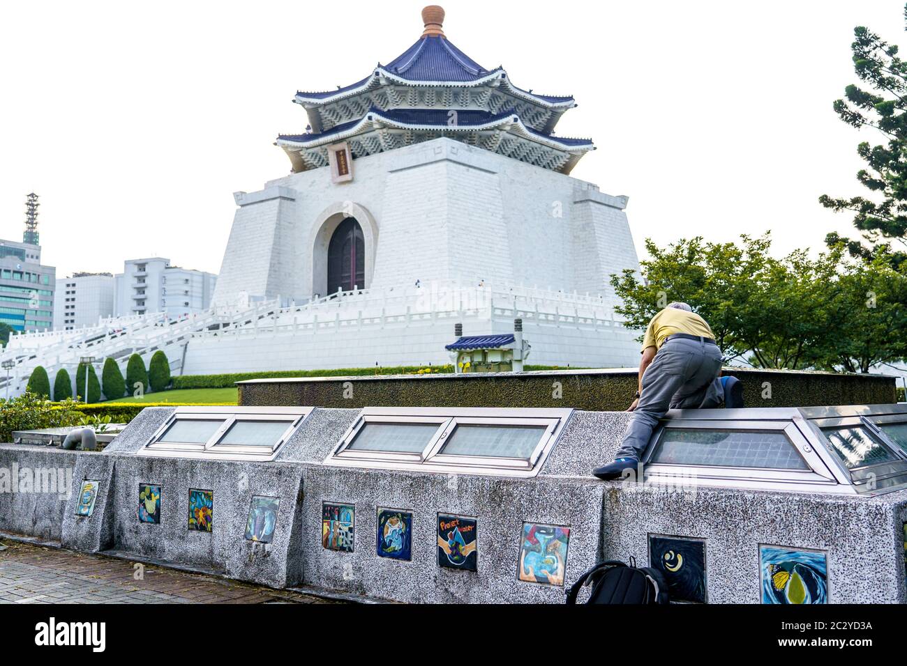 Person taking a picture of the Chiang Kai Shek Memorial Hall reflecting ...
