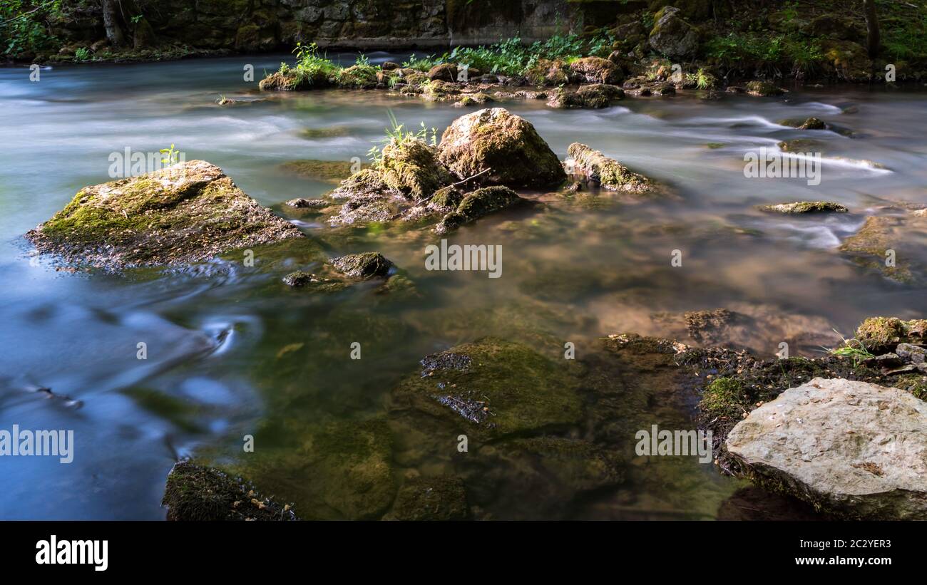 Warm light on river rocks Stock Photo - Alamy