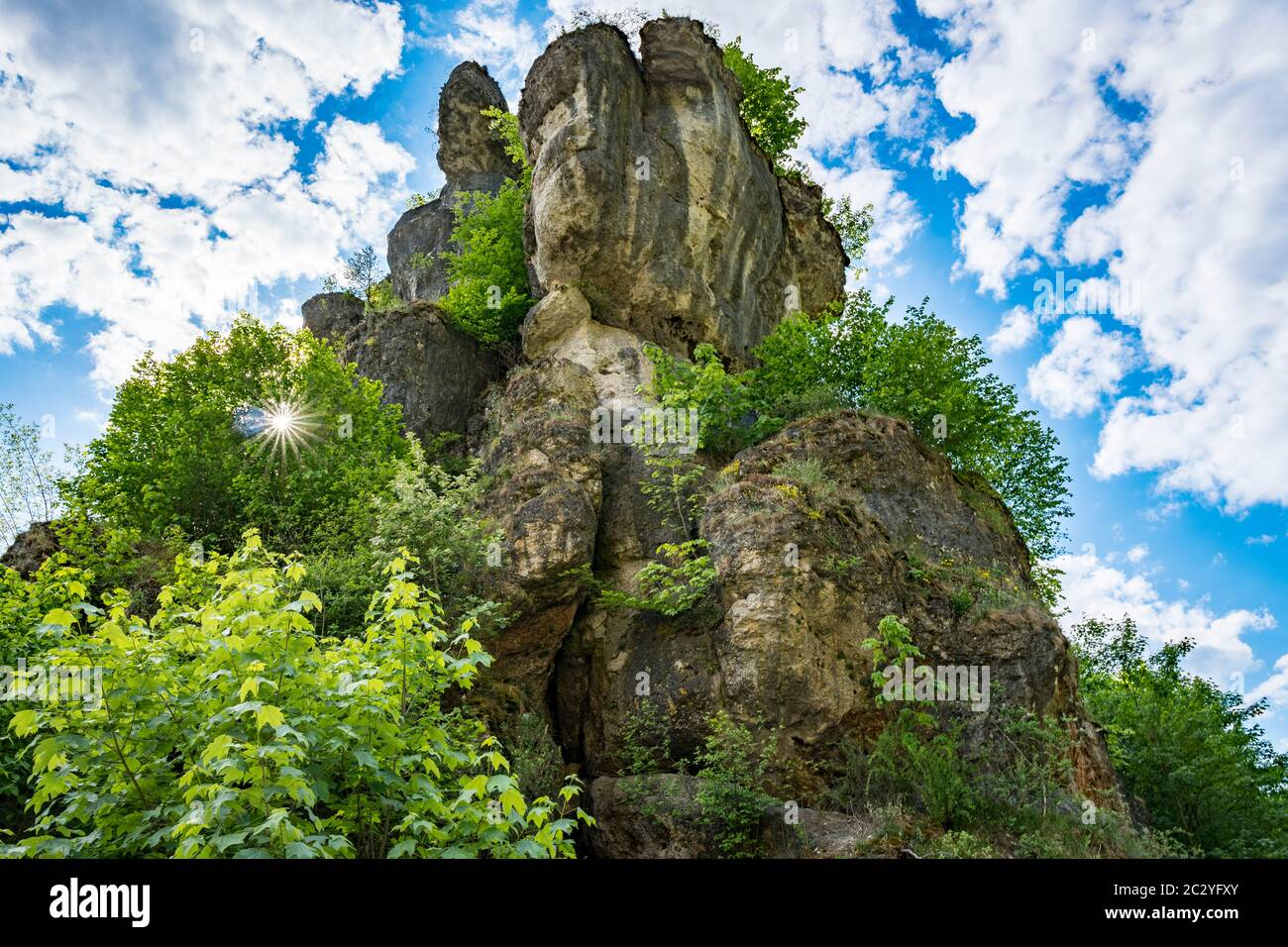 Rock formation reaching the clouds Stock Photo - Alamy