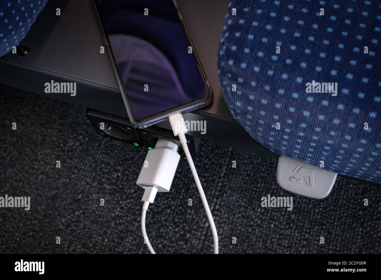 Charging phone on the train Stock Photo - Alamy