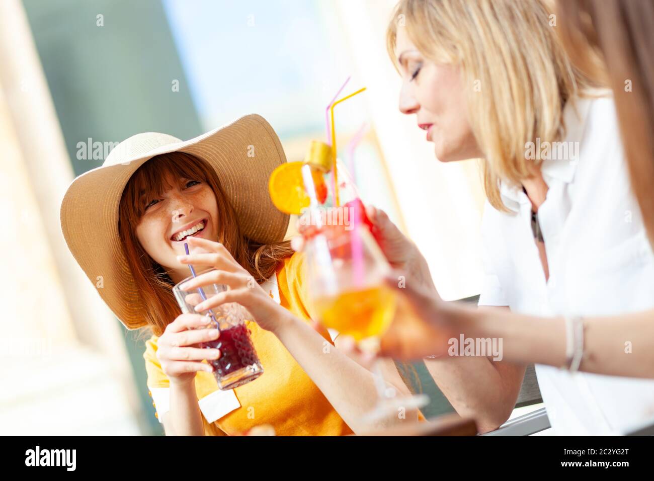 Three friends at the bar having a drink and conversation Stock Photo ...