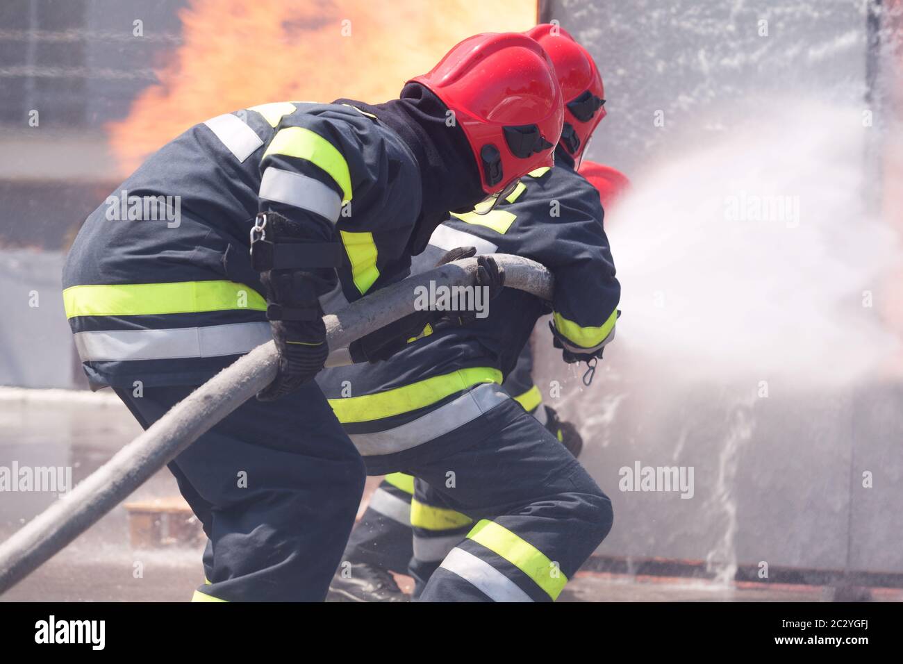 Fireman in action. Fire department training Stock Photo - Alamy