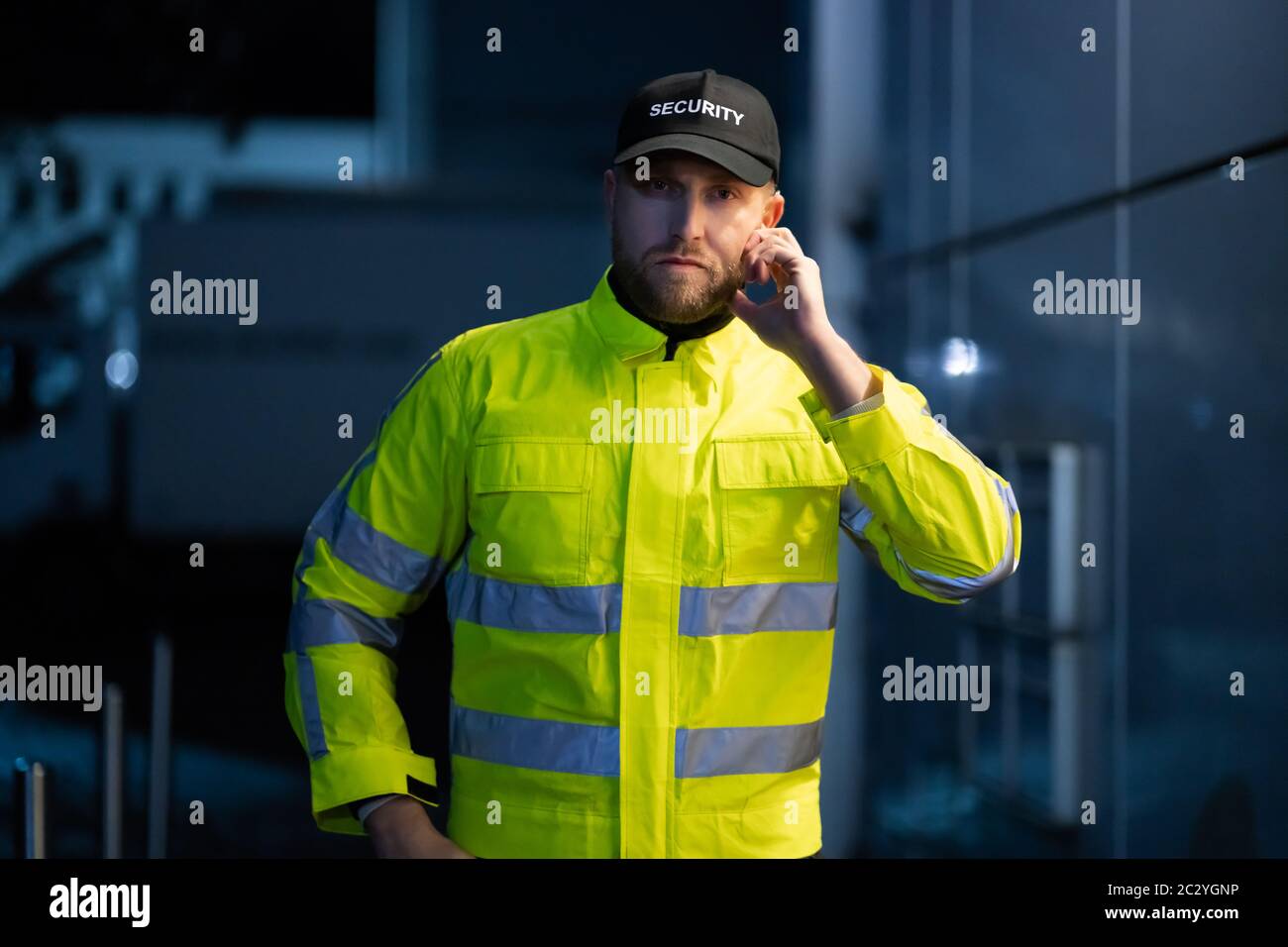Young Security Guard Standing In Front Of The Glass Door Entrance Stock ...