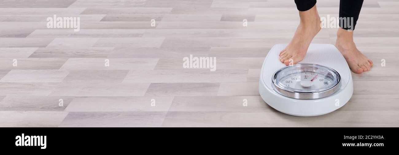 Close-up Of A Human Foot Stepping On Weighing Scale Stock Photo - Alamy