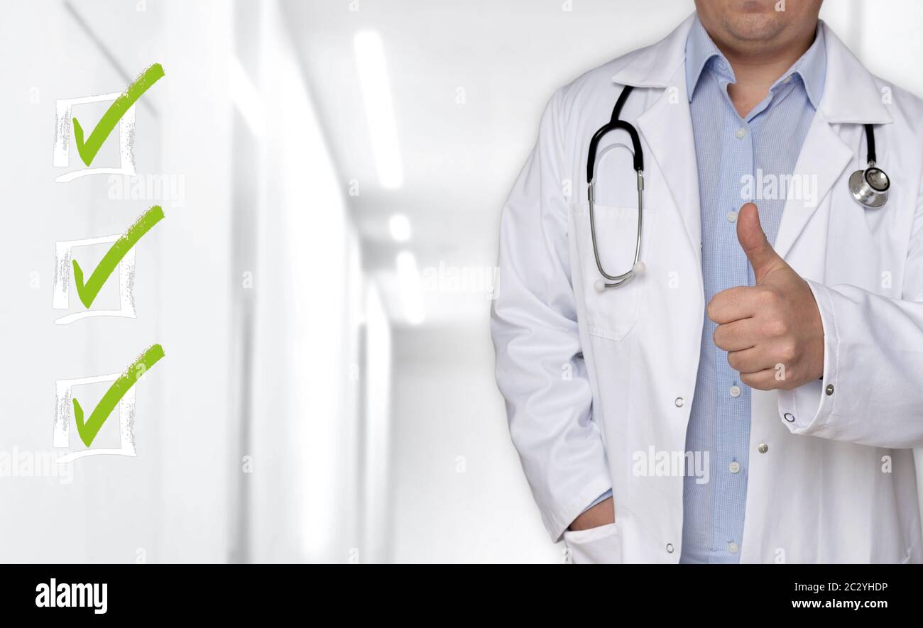Checklist concept and doctor with thumbs up Stock Photo - Alamy