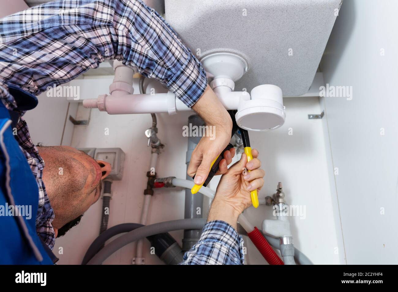 Men builder fixing pipe hi-res stock photography and images - Alamy