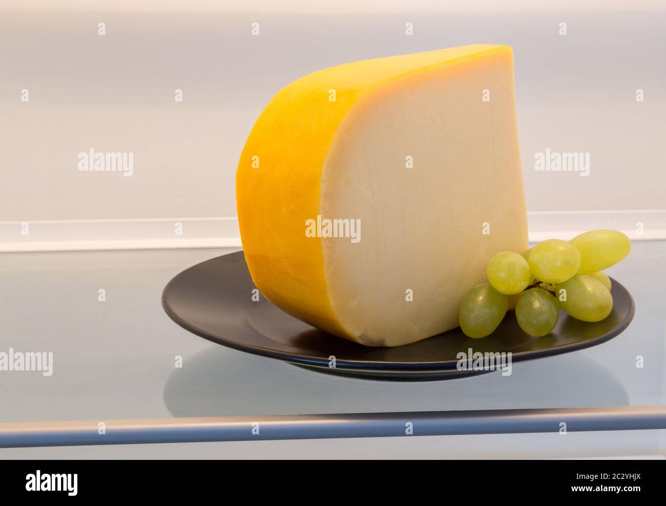 Cheese in open refrigerator concept Stock Photo - Alamy