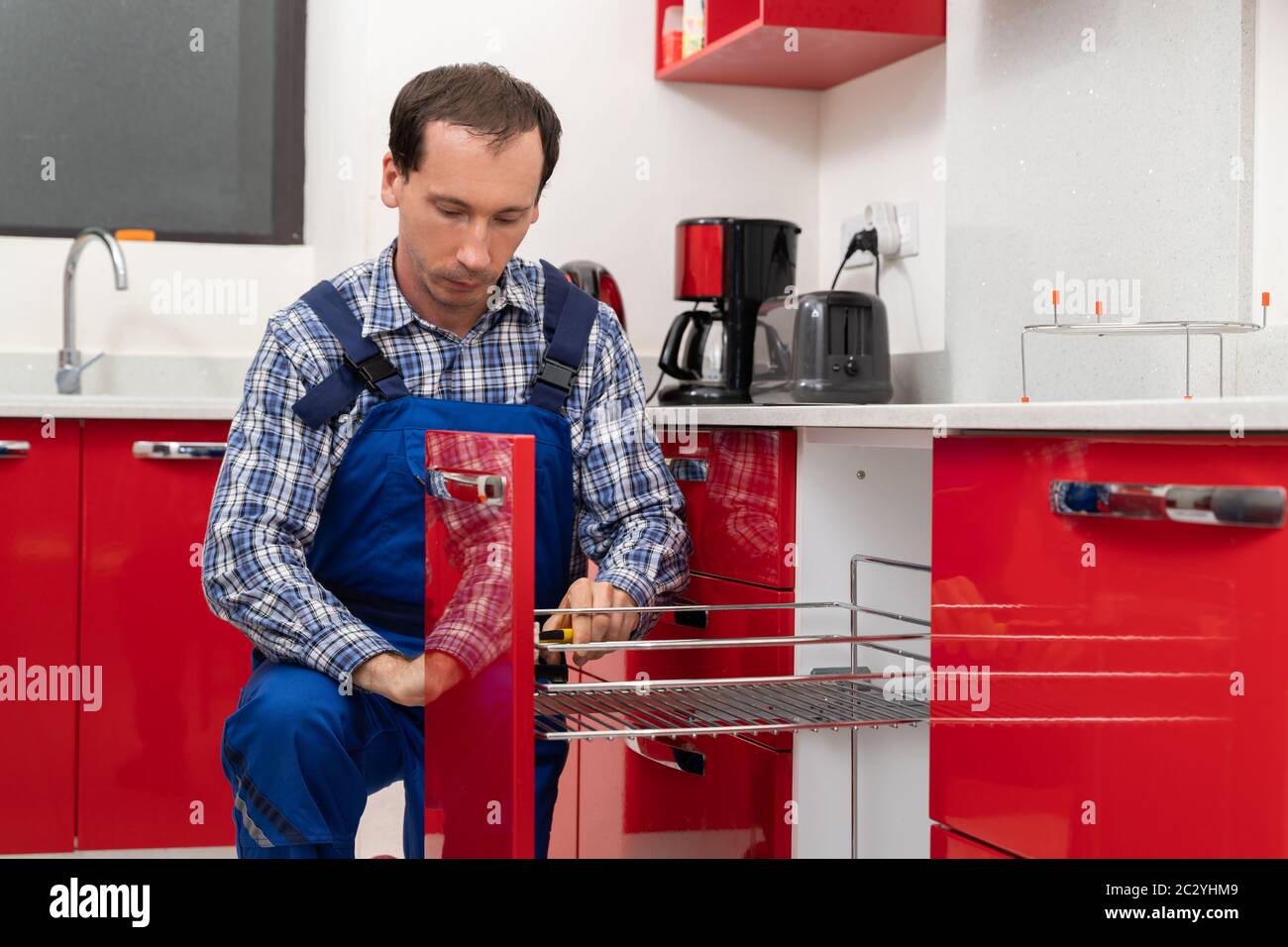 Close-up Of A Young Male Carpenter Installing Drawer Stock Photo - Alamy