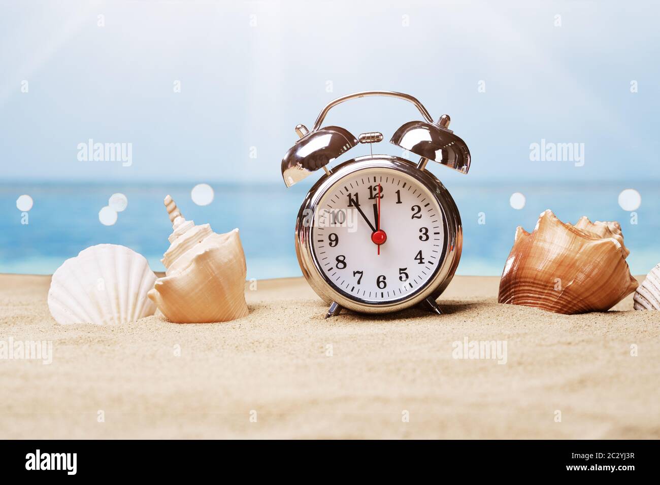 Alarm Clock In Sand On Sunny Tropical Beach Stock Photo - Alamy
