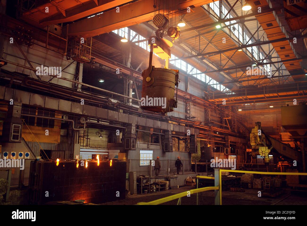 Crane with bucket of liquid metal on steel factory, metallurgical or ...