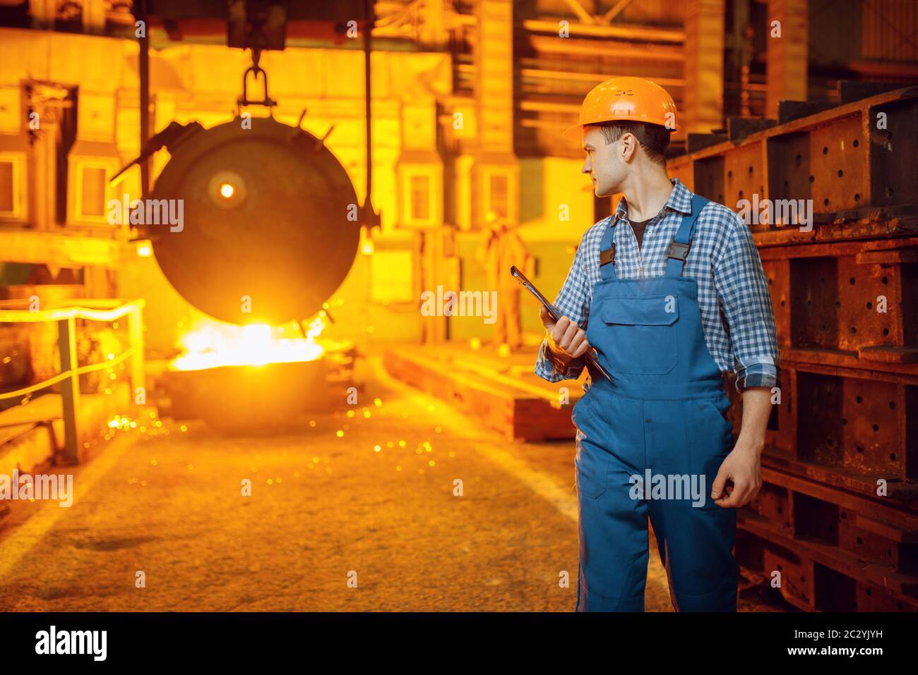 Steelmaker, furnace and liquid metal in basket, steel factory ...