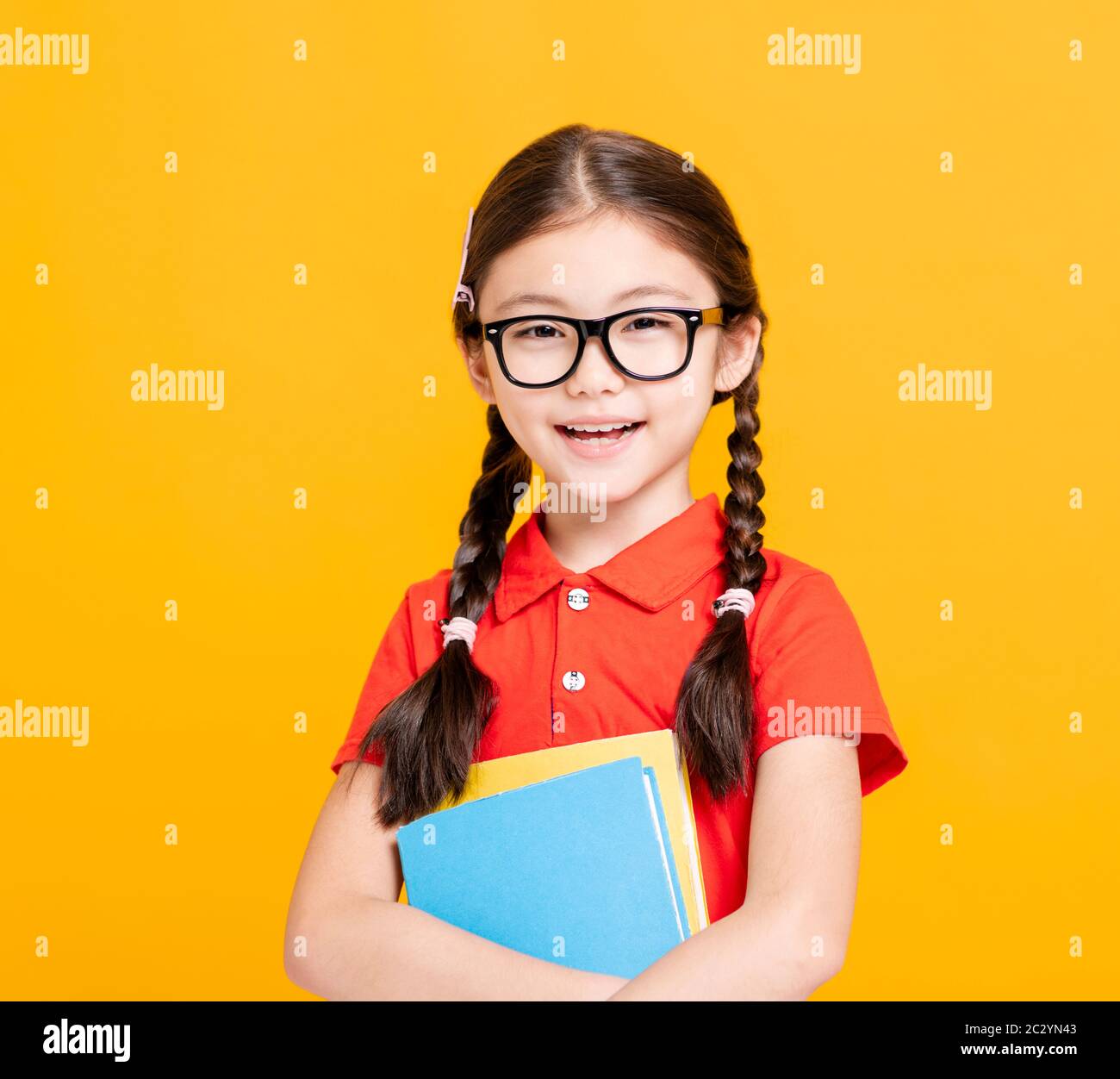 Adorable student girl holding the books Stock Photo - Alamy