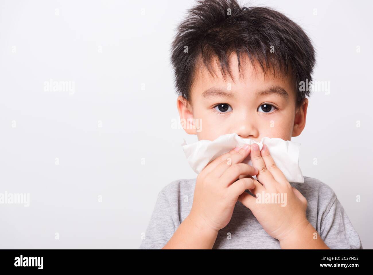 Closeup Asian face, Little children boy cleaning nose with tissue on ...