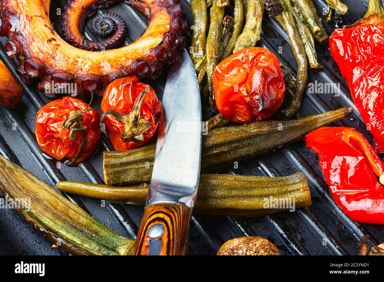 Octopus seafood vegetables in frying hi-res stock photography and ...
