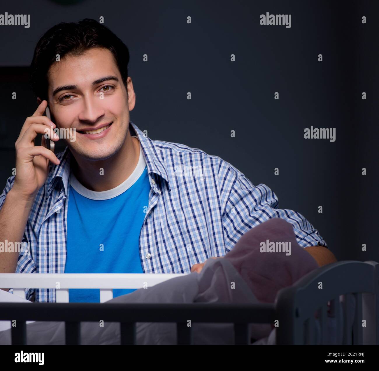 Happy dad looking after newborn baby at night Stock Photo - Alamy