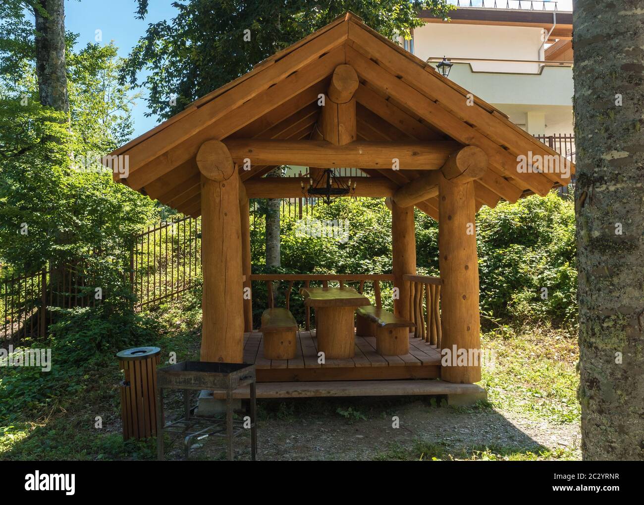 Beautiful summer house from a log of a large tree with barbecue for ...