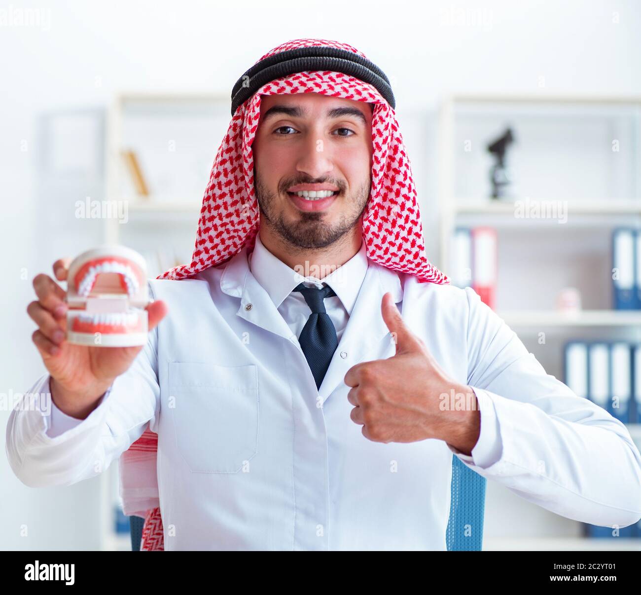 Arab dentist working on new teeth implant Stock Photo - Alamy