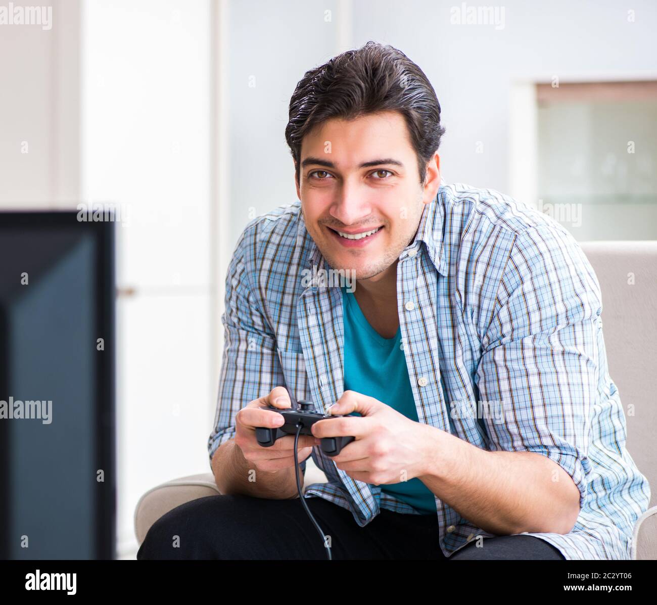 Man playing computer game at home Stock Photo - Alamy