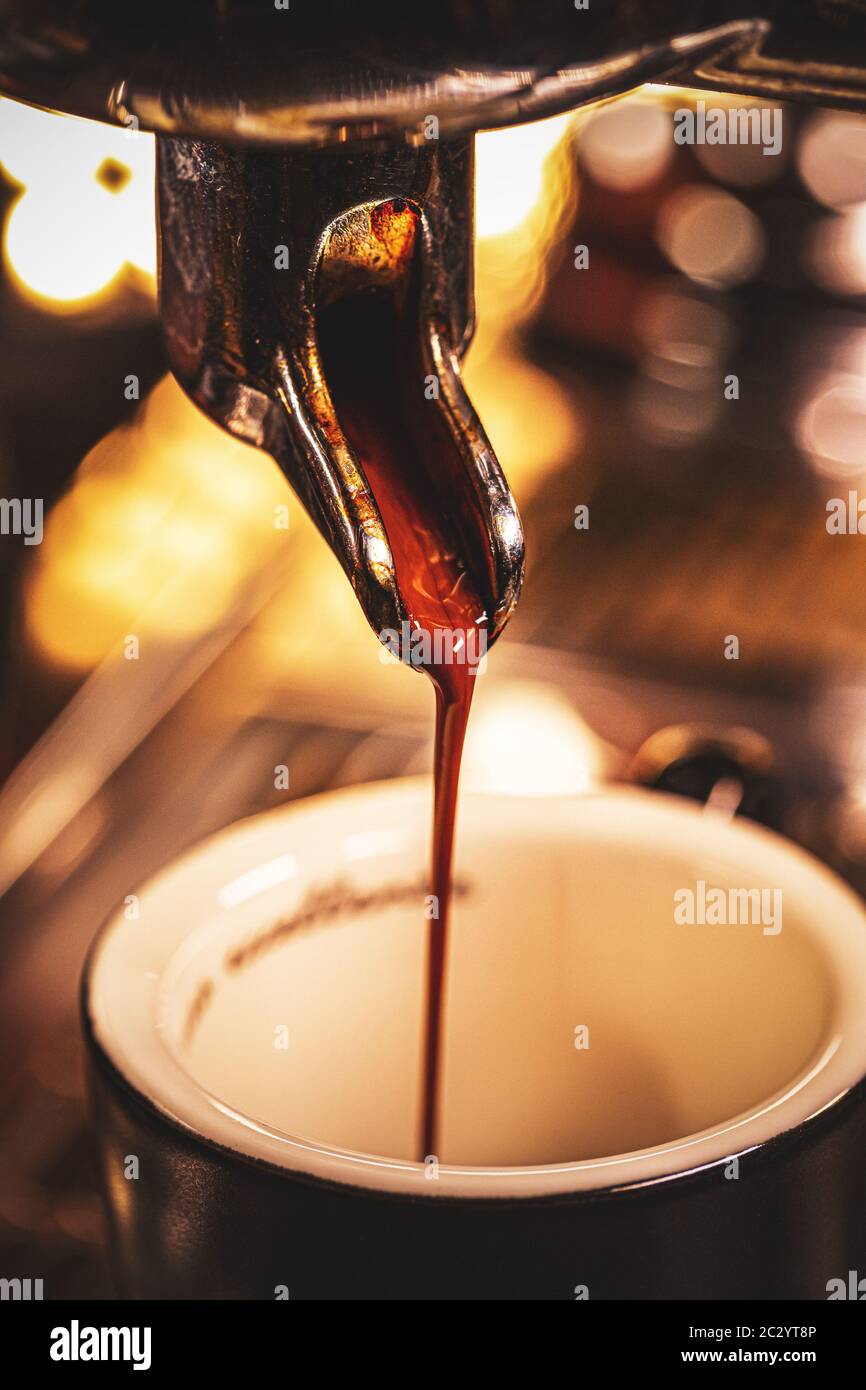 Espresso coffee is flowing out of the coffee maker Stock Photo - Alamy