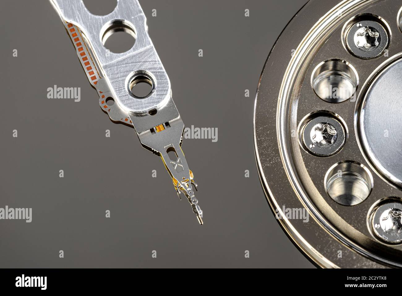 Macro shot of a magnetic needle on a hard disk platter, open HDD disk ...