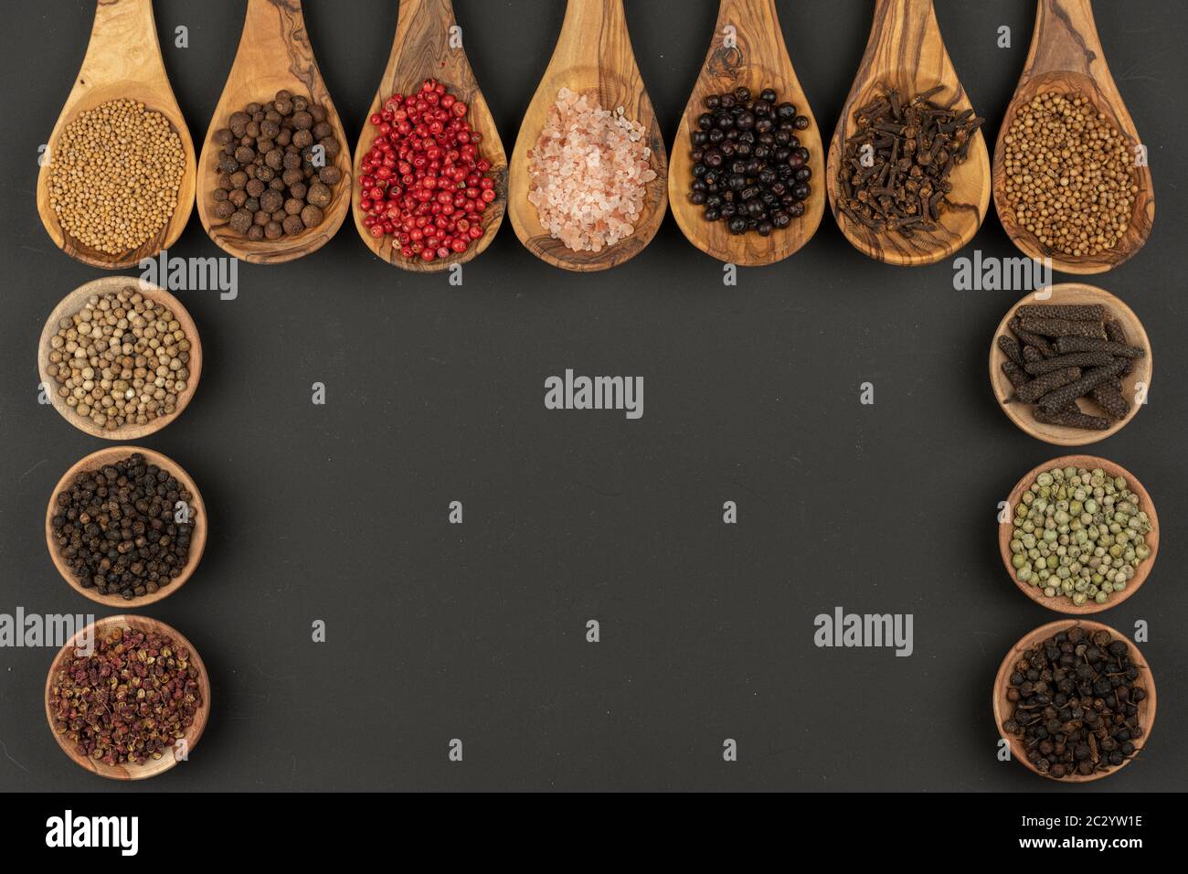 Seven cooking spoons made of olive wood and six small wooden bowls ...