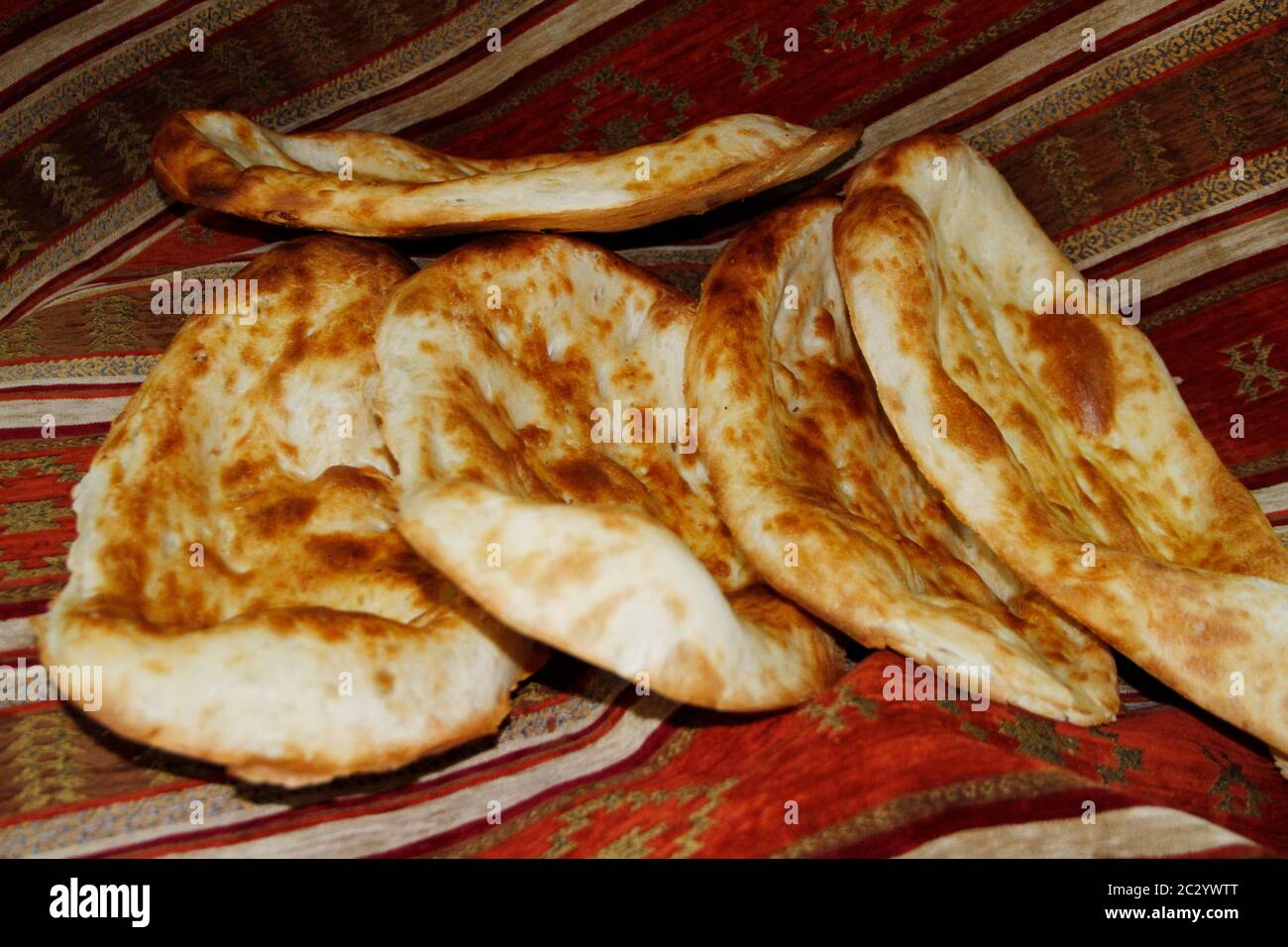 Finely fried wheat bread on the ethnic tablecloth Stock Photo - Alamy