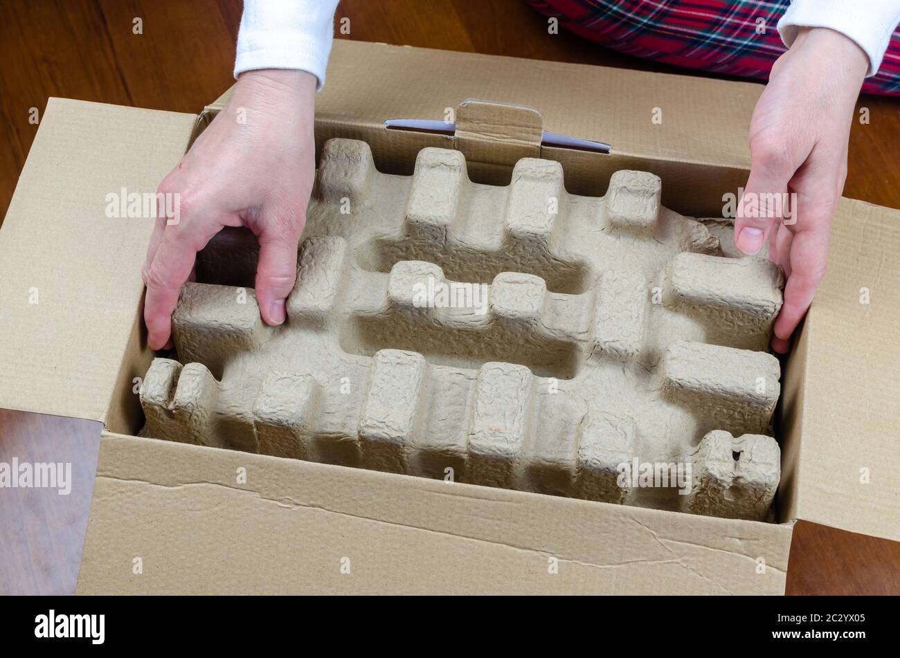 Woman's hands while unpacking a new box with an product Stock Photo - Alamy