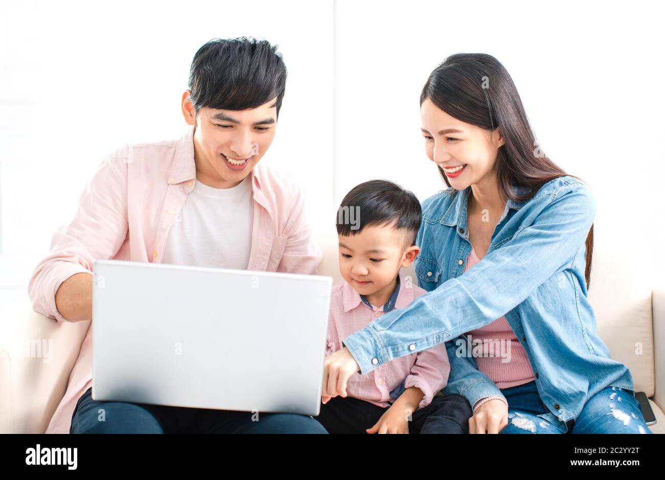 happy family watching the laptop on sofa Stock Photo - Alamy
