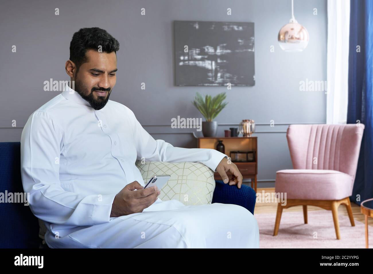 Arab man sitting in sofa hi-res stock photography and images - Alamy
