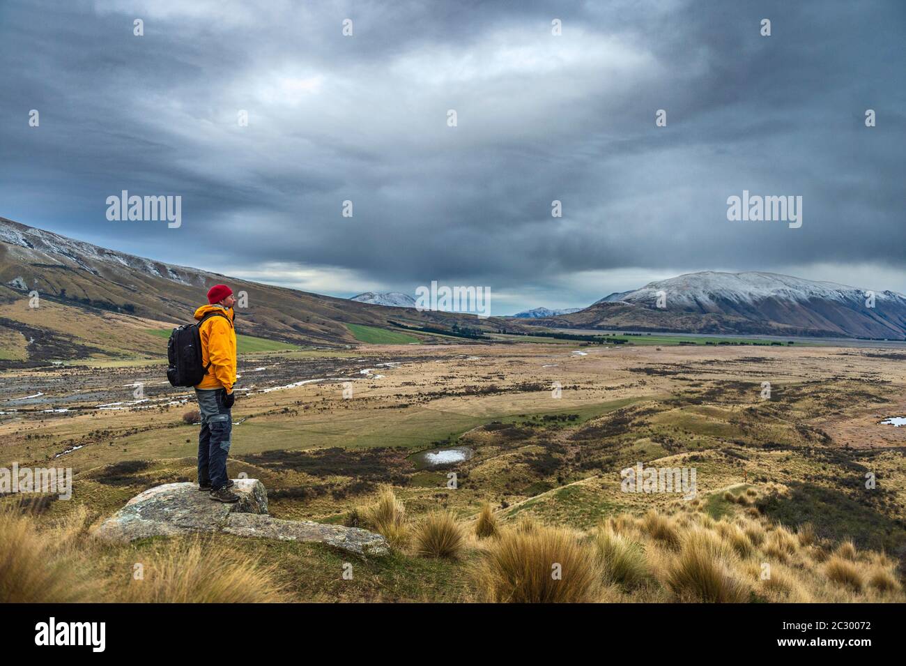 Hiker male, looking over the Rangitata River Valley, Ashburton Lakes ...