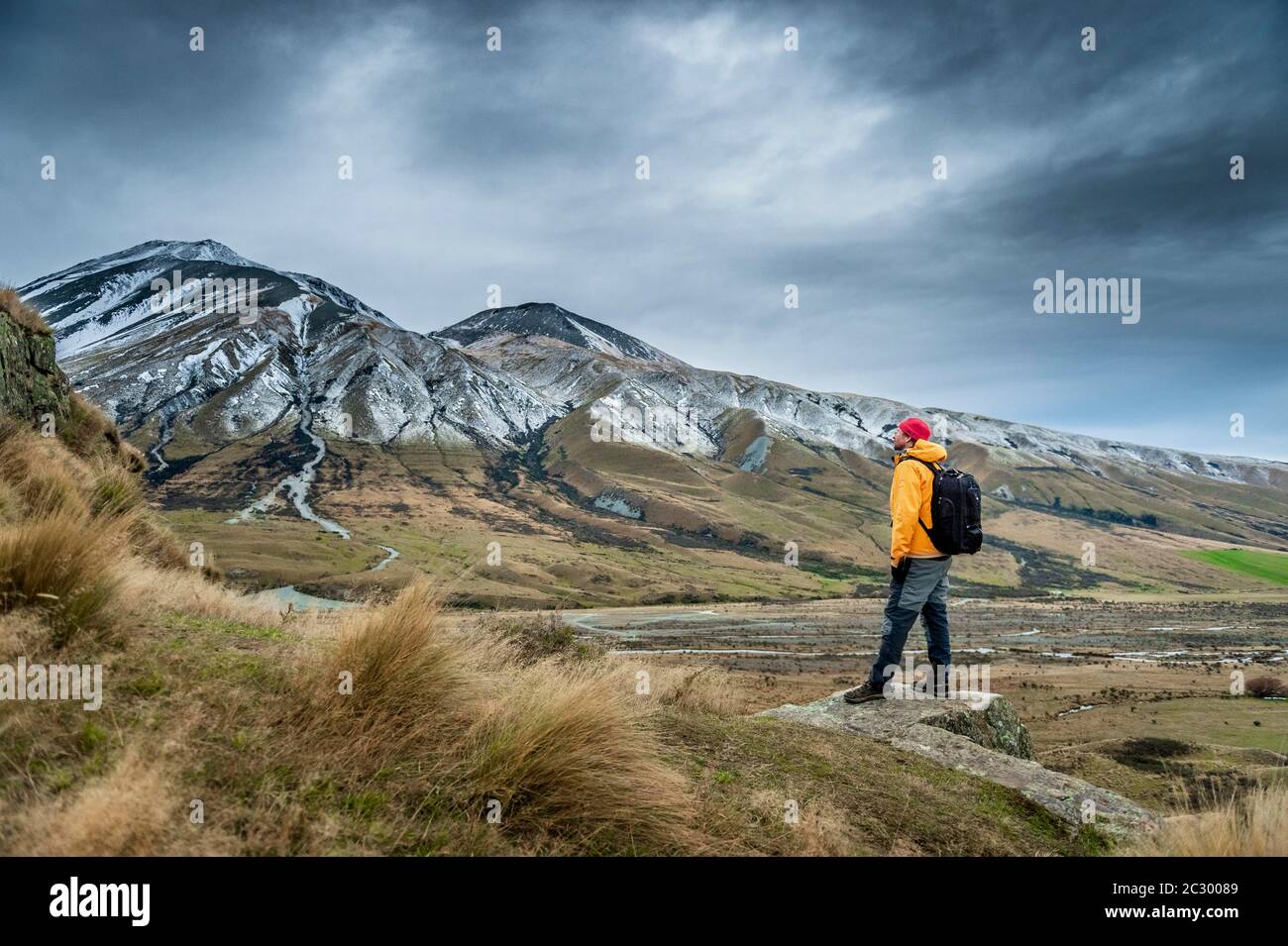 Hiker male, looking over the Rangitata River Valley, Ashburton Lakes ...