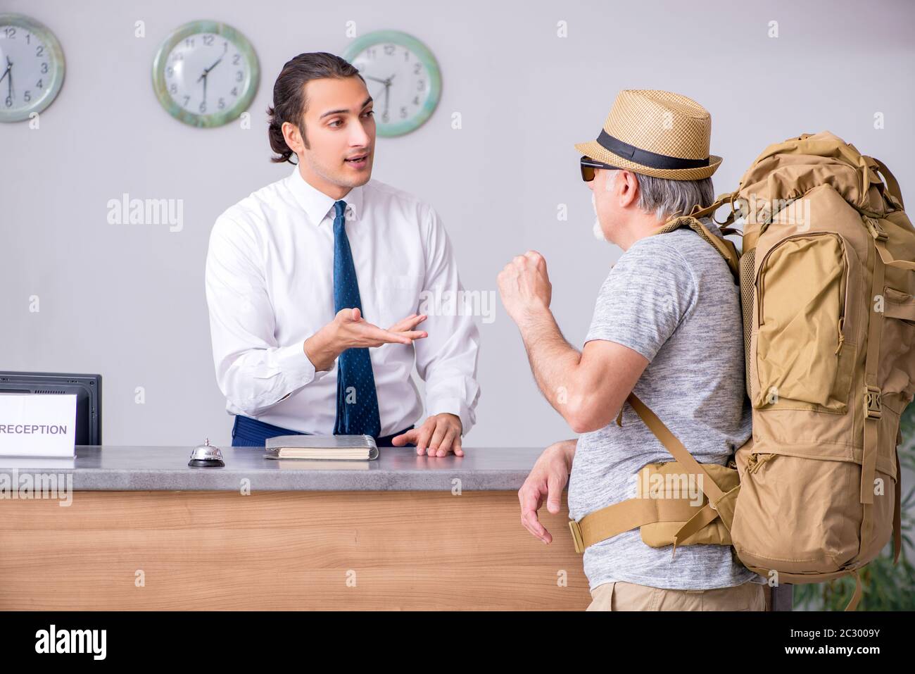 Backpacker at the hotel reception Stock Photo - Alamy