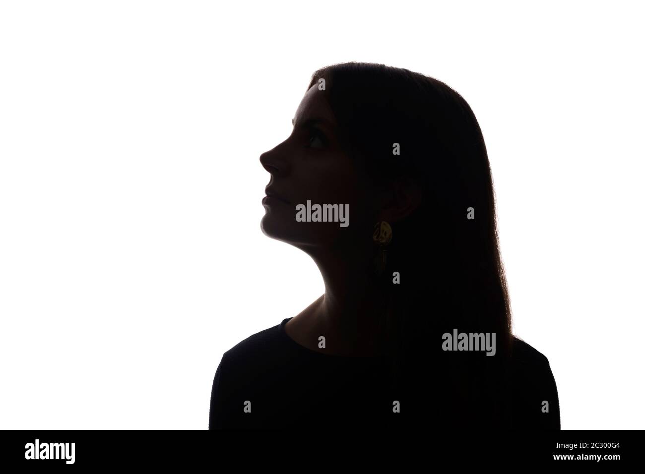 Portrait of a beautiful young girl looking up concept and symbol of ...