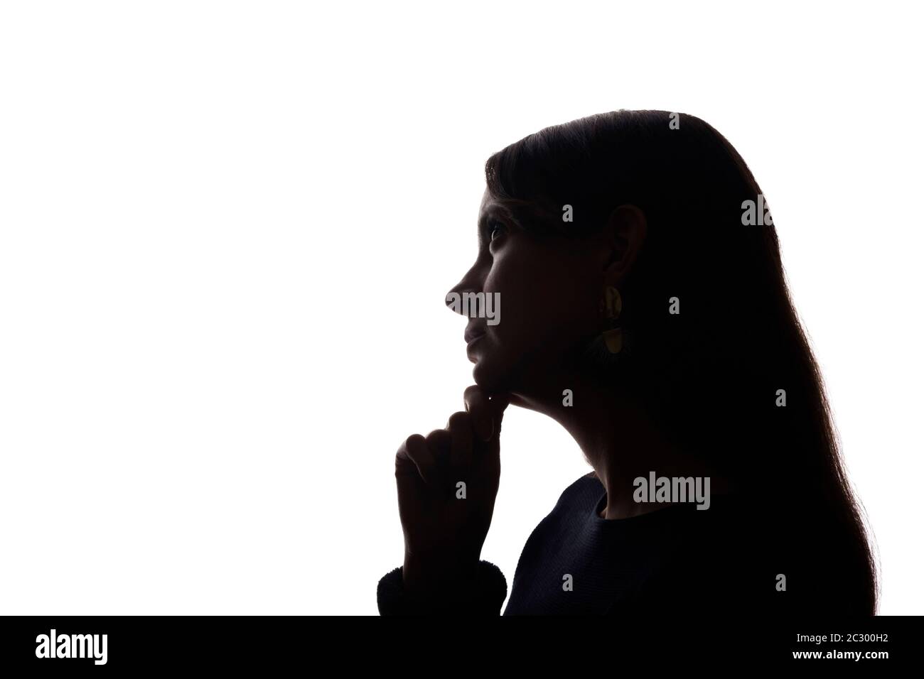 Portrait of a beautiful young girl looking up concept and symbol of ...