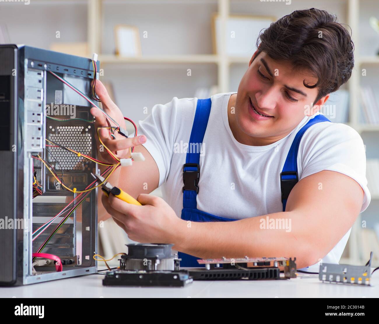 Computer repairman repairing desktop computer Stock Photo - Alamy