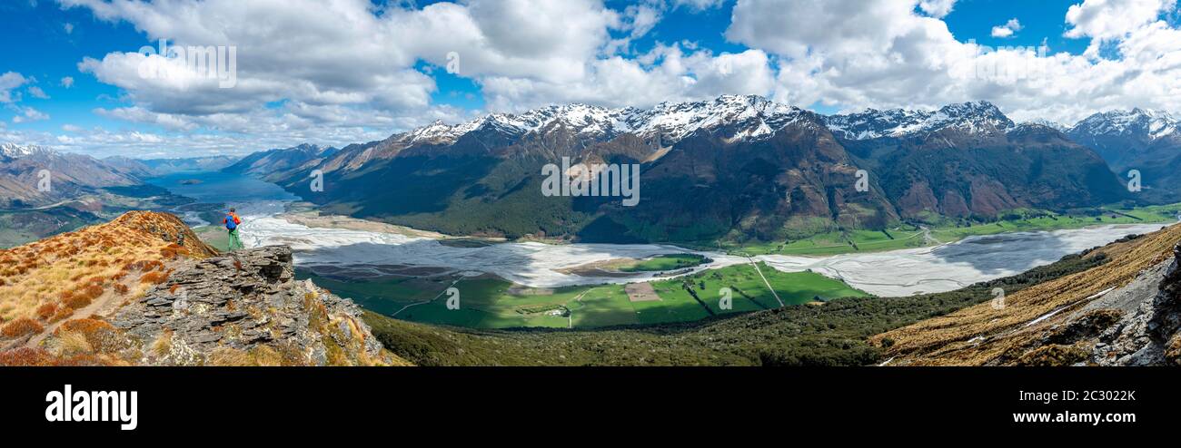 Hiker on the summit of Mount Alfred, views of Lake Wakatipu and Dart ...