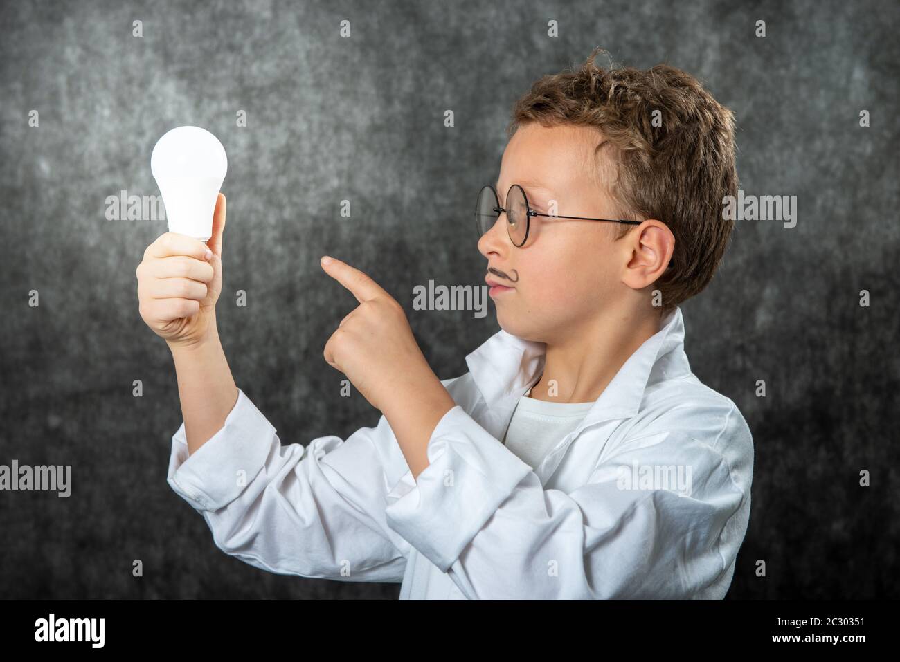 cute smiling child boy with a light bulb Stock Photo - Alamy